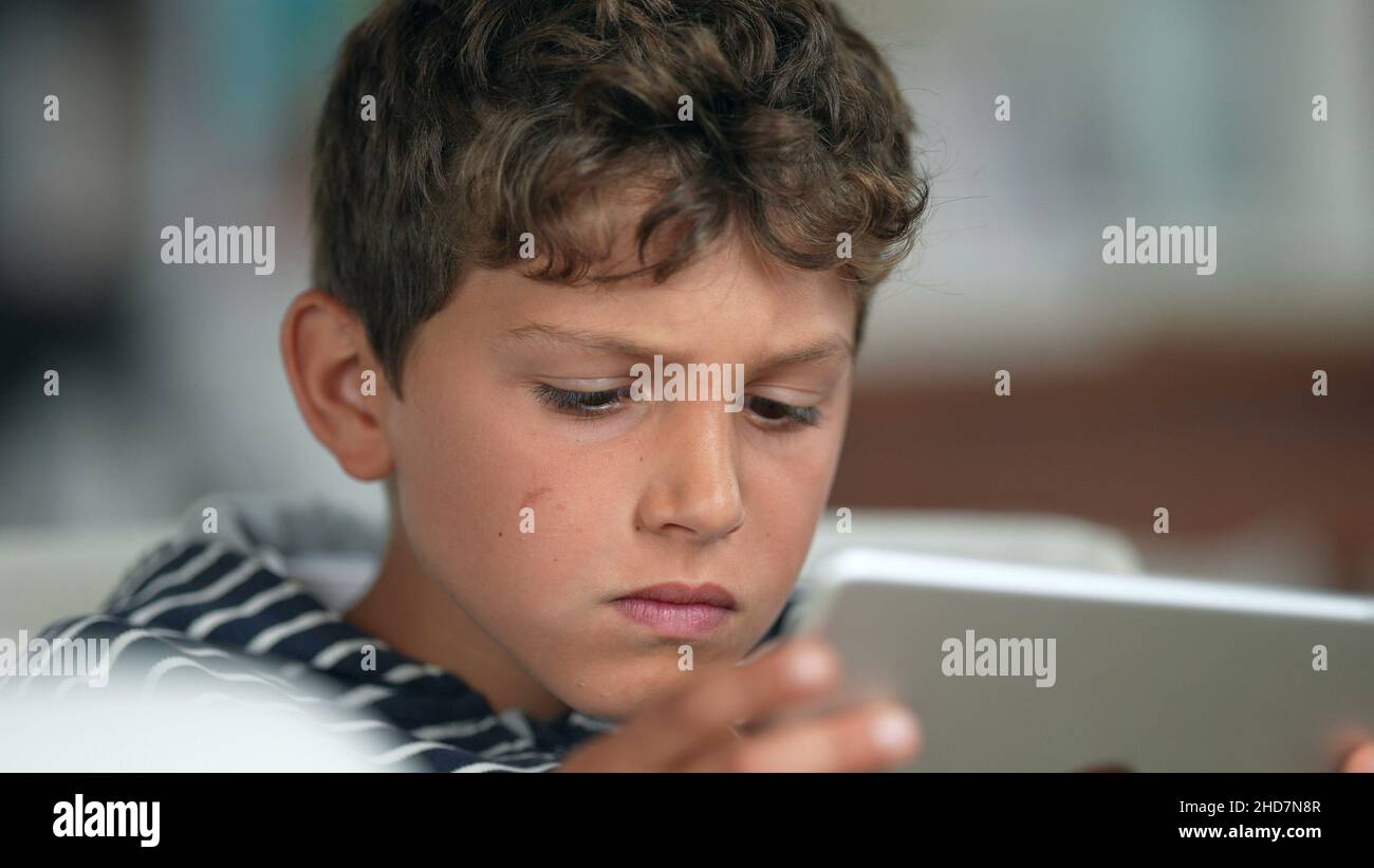 Child amazed reaction to content online holding tablet Stock Photo - Alamy