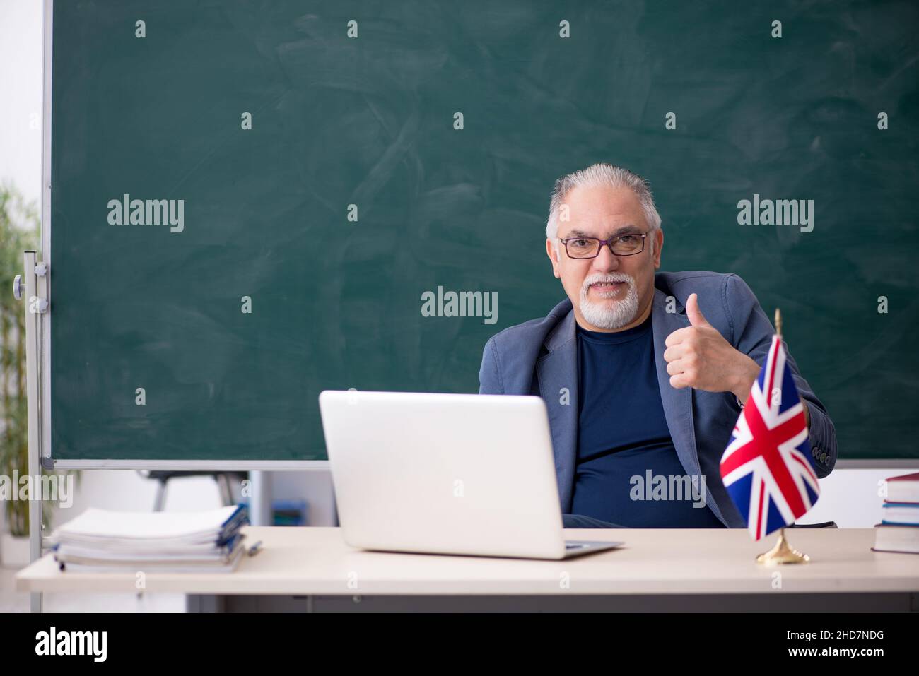 Old english language teacher in the classroom Stock Photo - Alamy