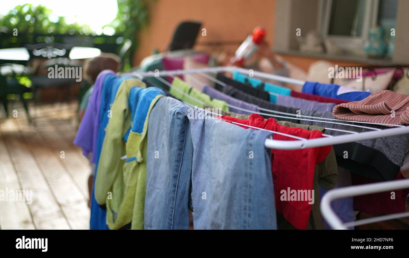 Drying of colourful clothes. Laundry drying racks Stock Photo - Alamy