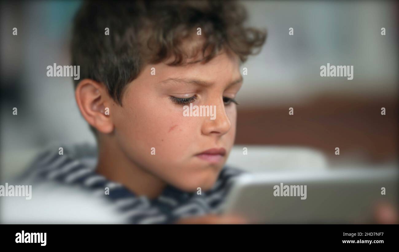 Child surprised reaction holding tablet. Boy WOW face emotion Stock ...