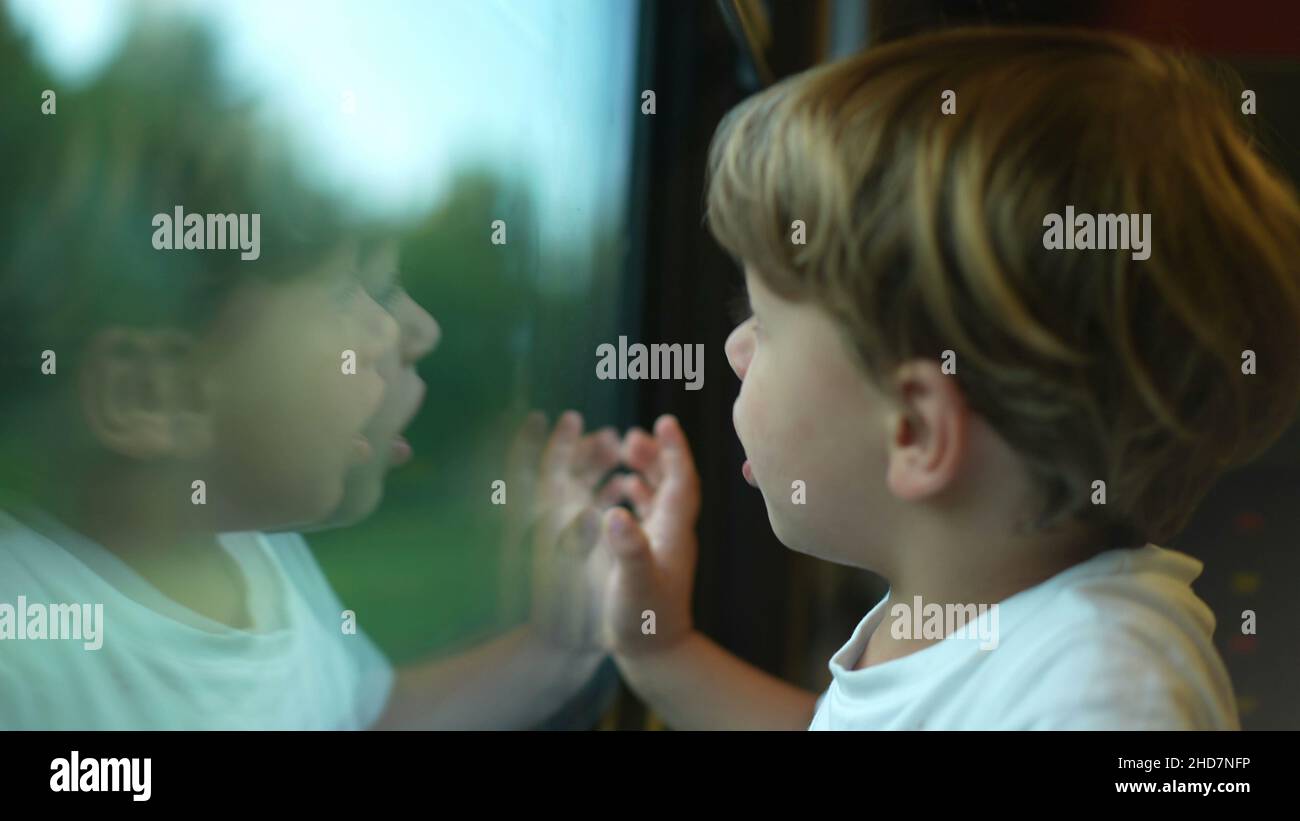 Child traveling by train, little boy staring out train window Stock ...