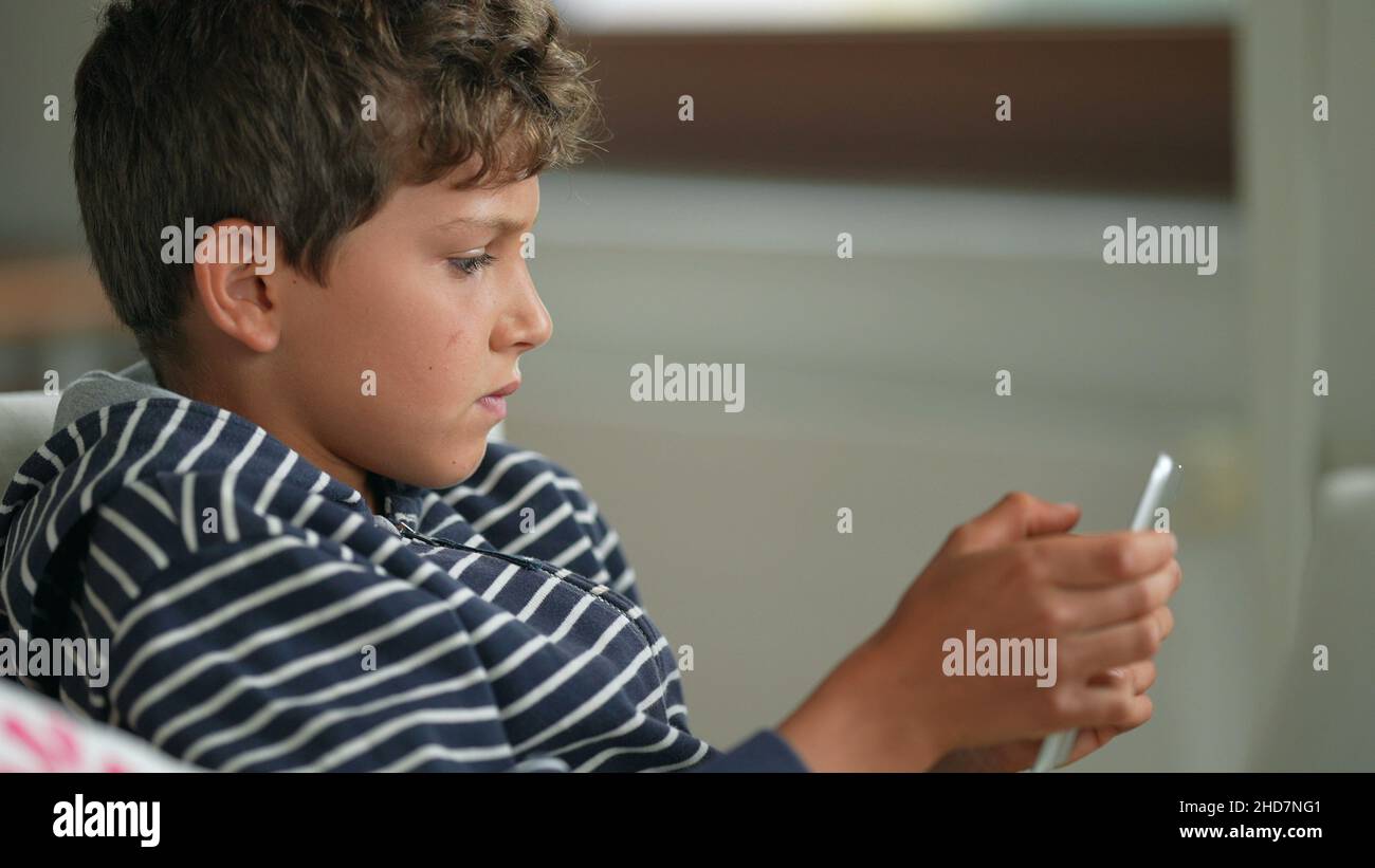 Child using tablet device. Young boy holding screen Stock Photo - Alamy