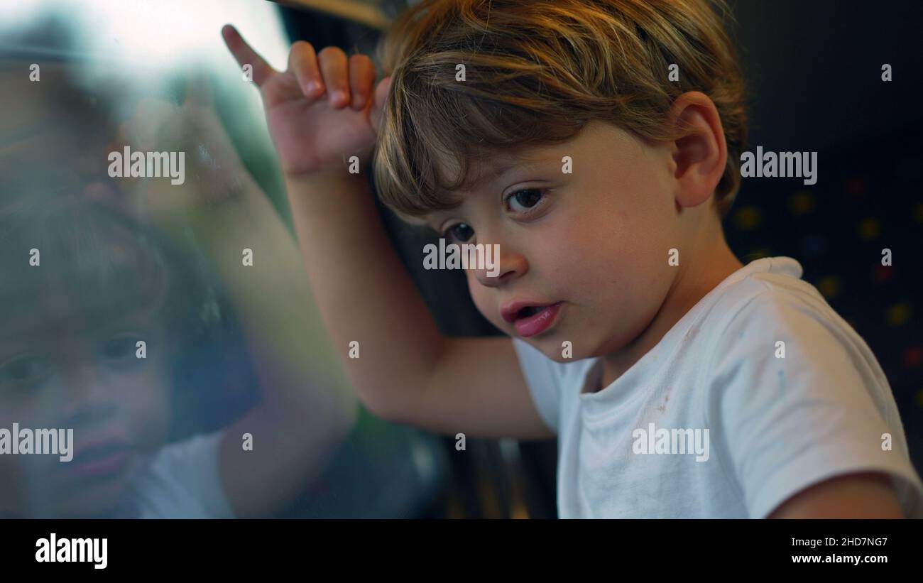Child traveling by train, little boy staring out train window Stock ...