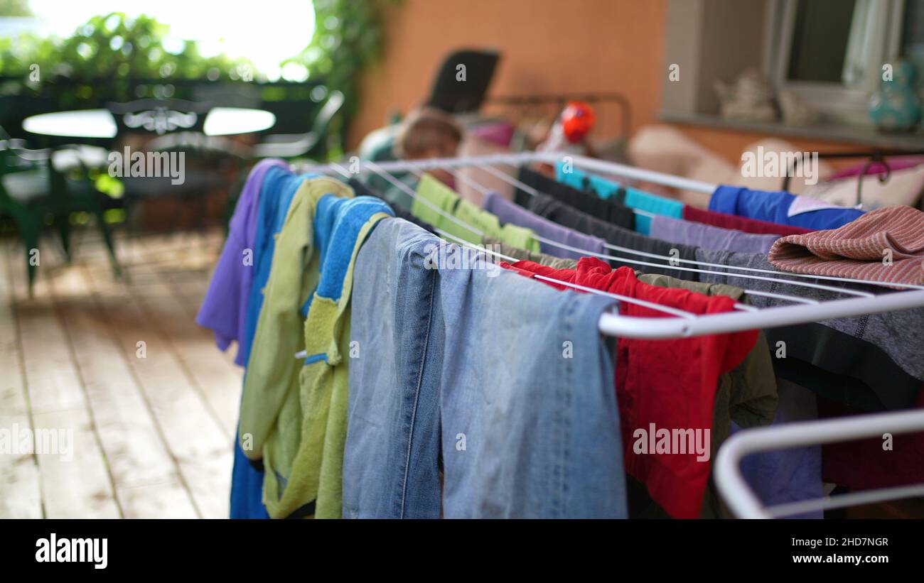 Drying of colourful clothes. Laundry drying racks Stock Photo - Alamy