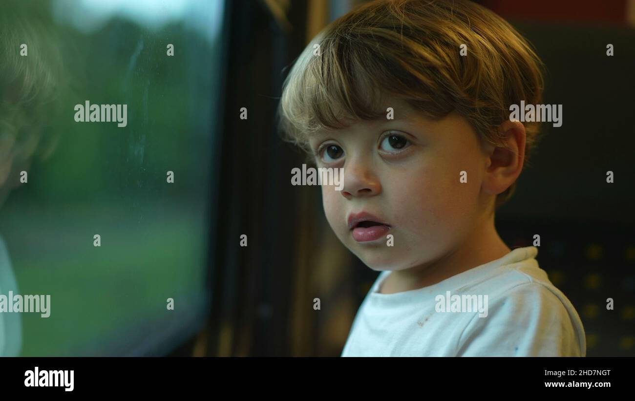 Child traveling by train, little boy staring out train window Stock ...