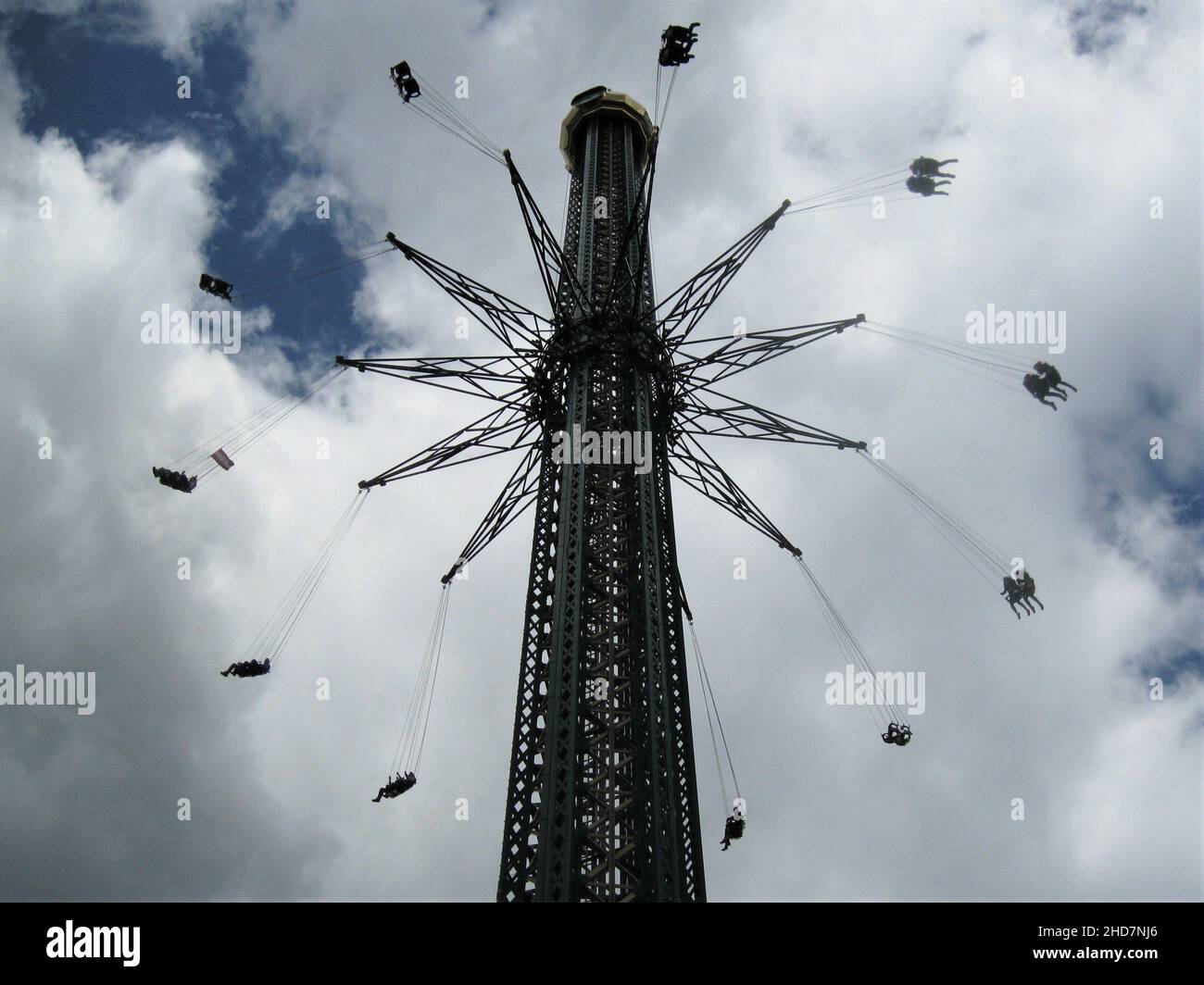 Entertainment concept - High spinning swing carousel from below in ...