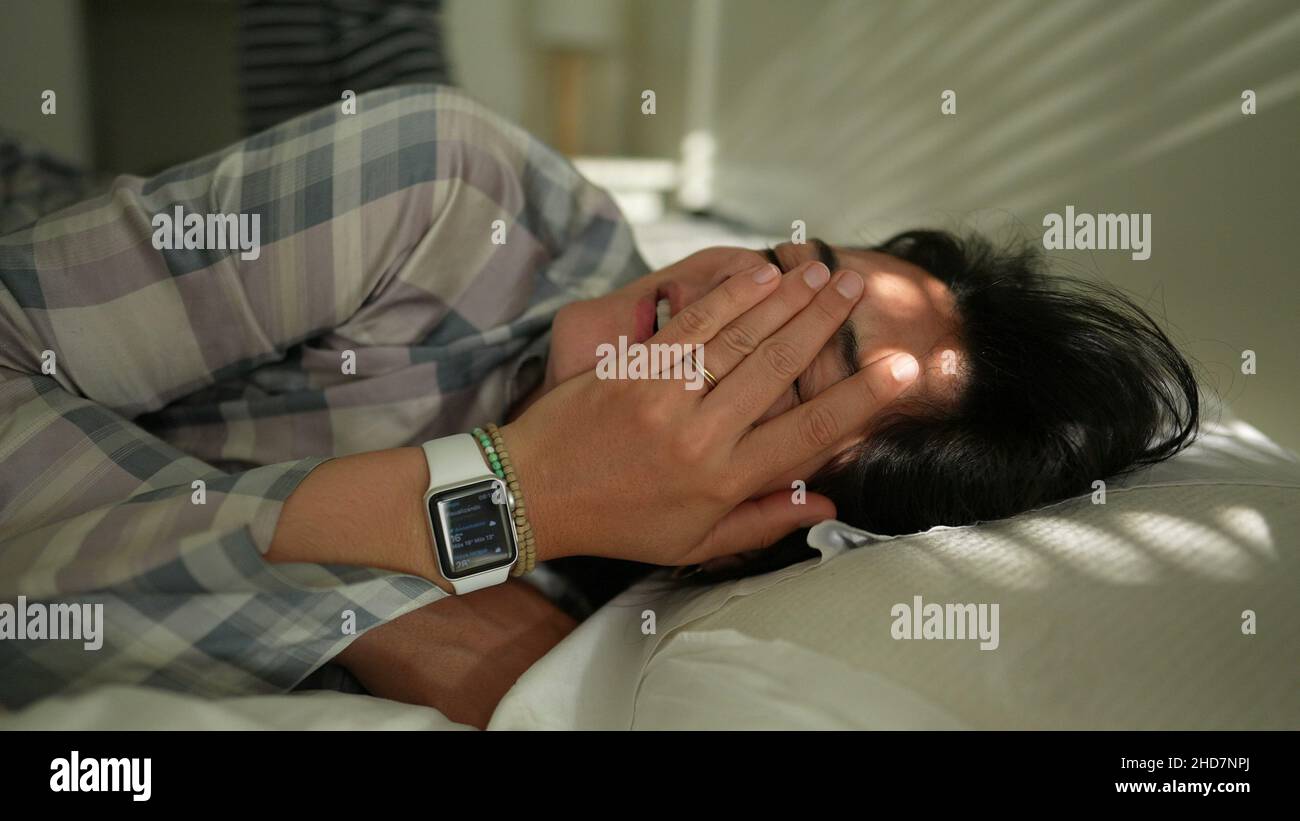 Woman waking up in the morning lying in bed real life authentic Stock ...