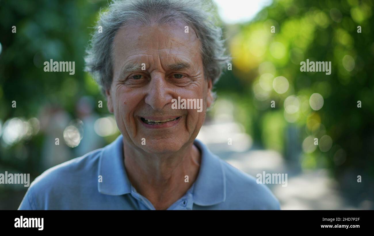 Happy senior man walking forward smiling. One older person walks in ...