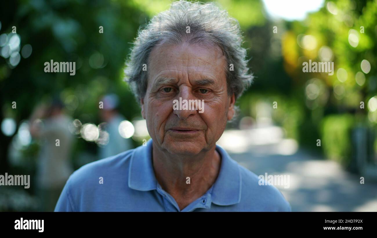 Happy senior man walking forward smiling. One older person walks in ...