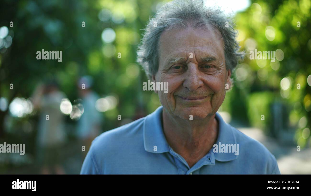 Happy senior man walking forward smiling. One older person walks in ...