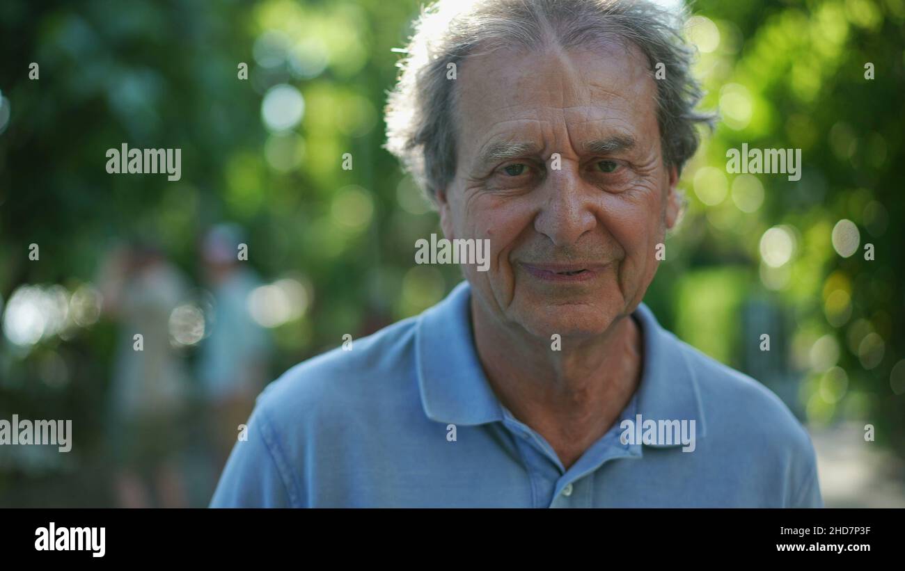 Happy senior man walking forward smiling. One older person walks in ...