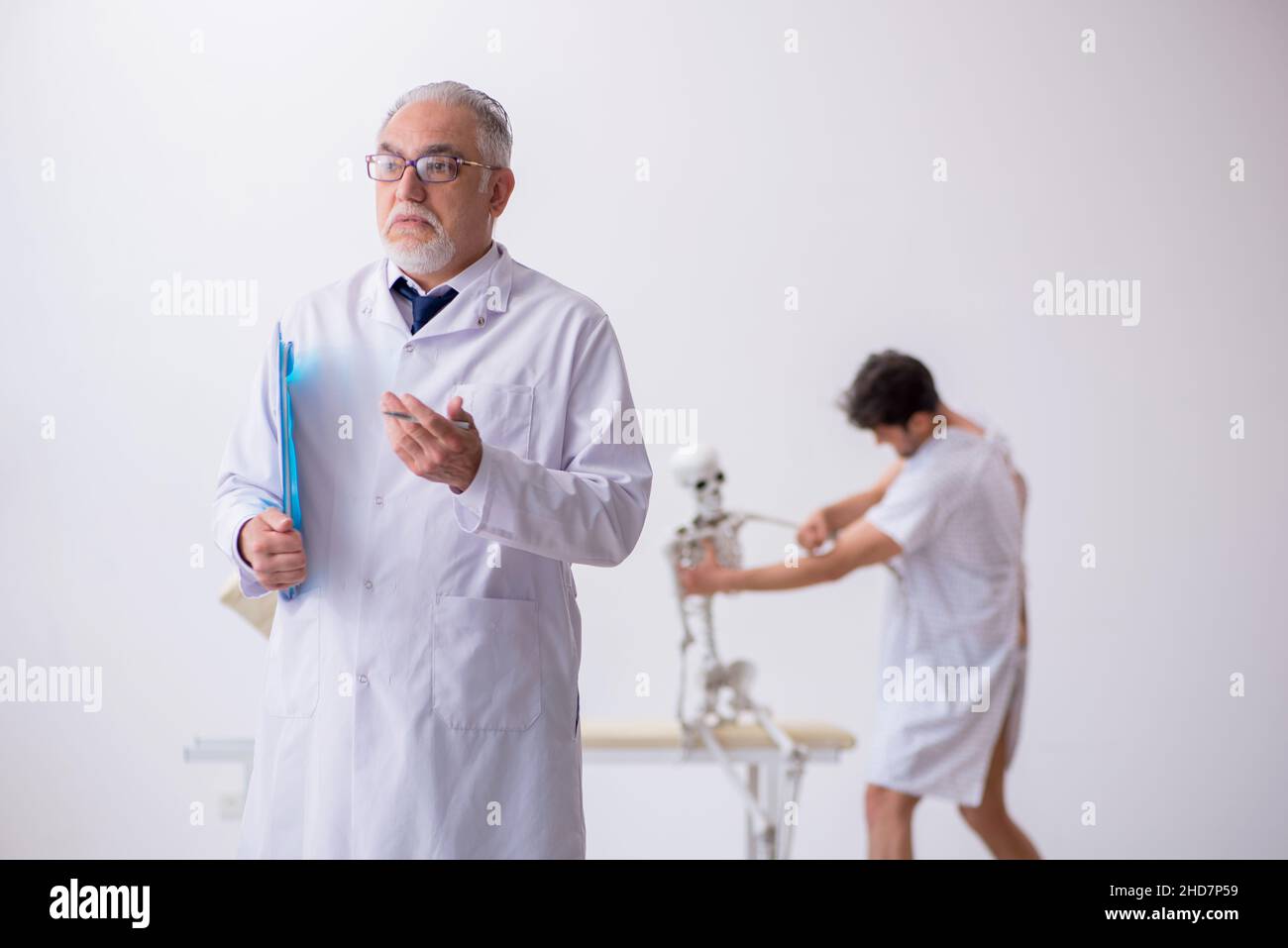 Old doctor psychiatrist examining young male patient Stock Photo - Alamy