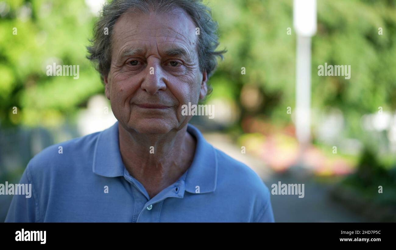 Happy senior man walking forward smiling. One older person walks in ...