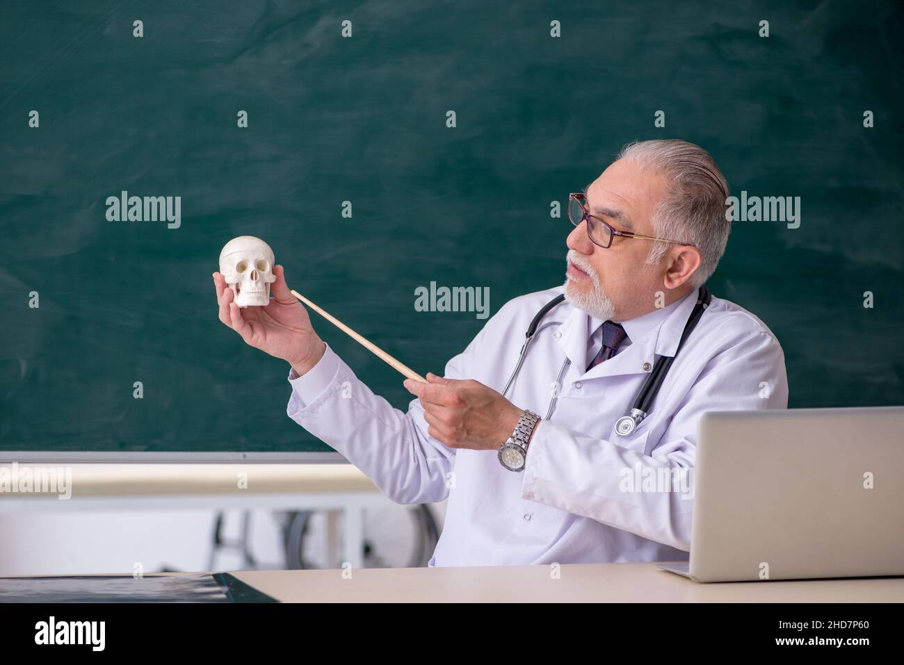 Old doctor teacher in front of blackboard Stock Photo - Alamy