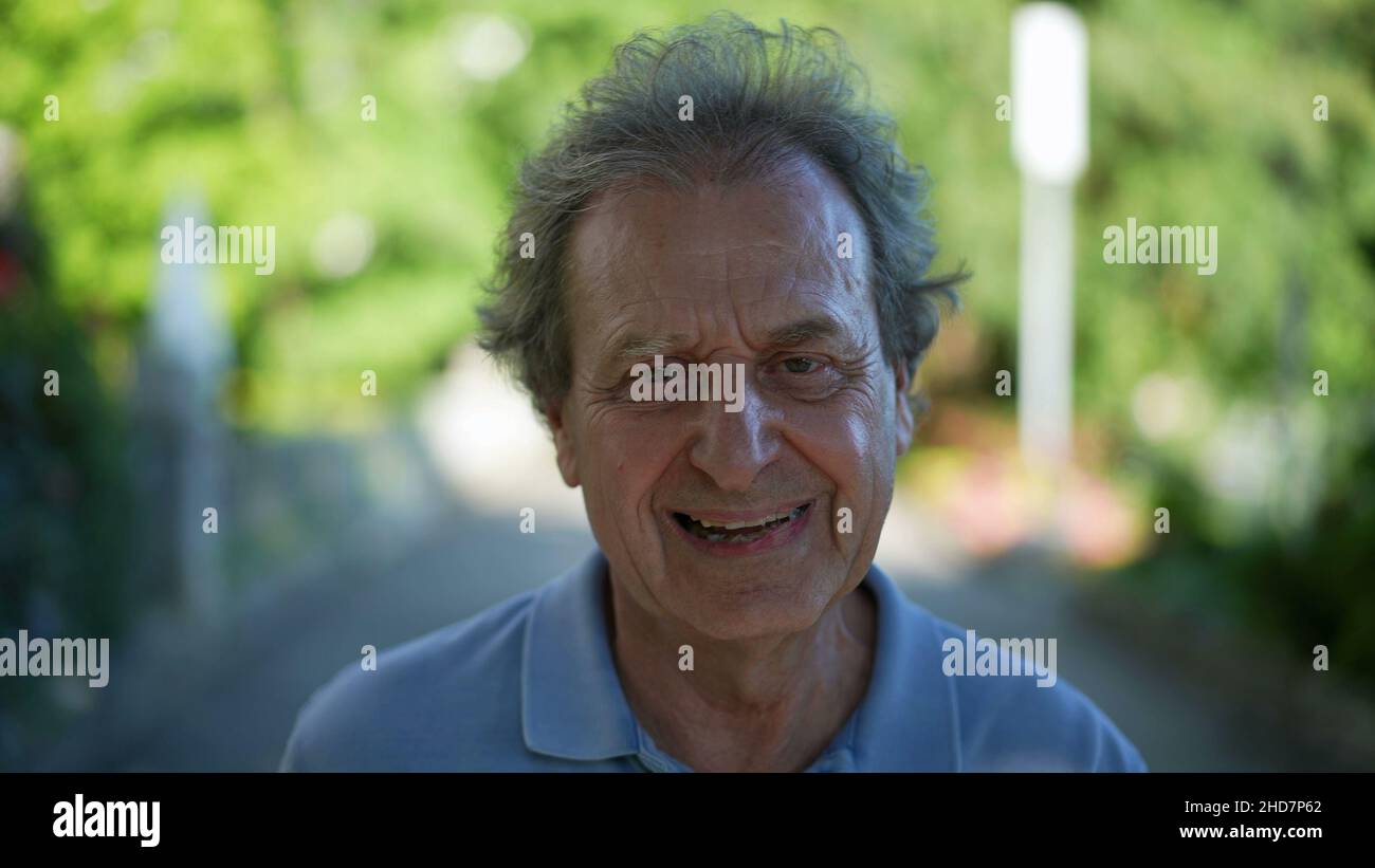 Happy senior man walking forward smiling. One older person walks in ...