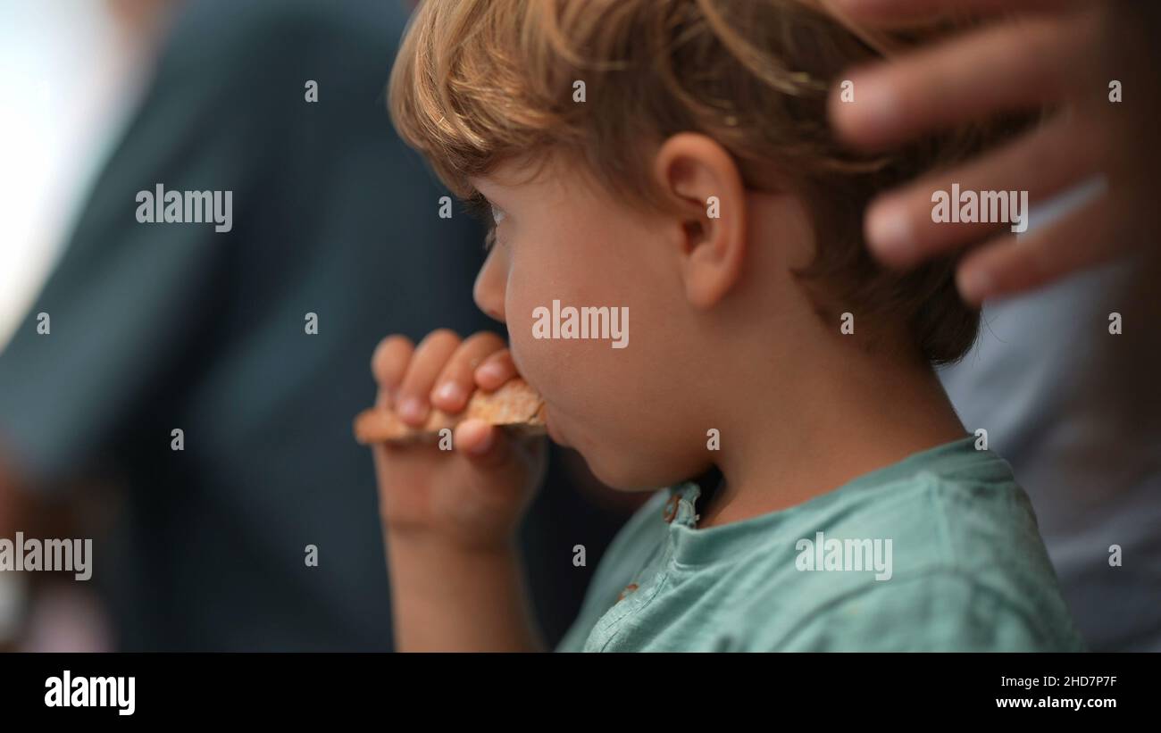 Little boy eating piece of bread, child eats food Stock Photo - Alamy