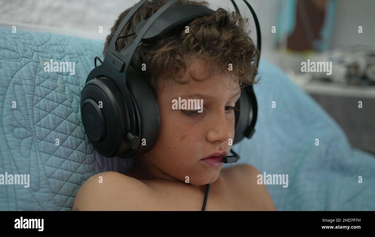 Little boy playing video-game on tablet wearing headset with mic Stock ...
