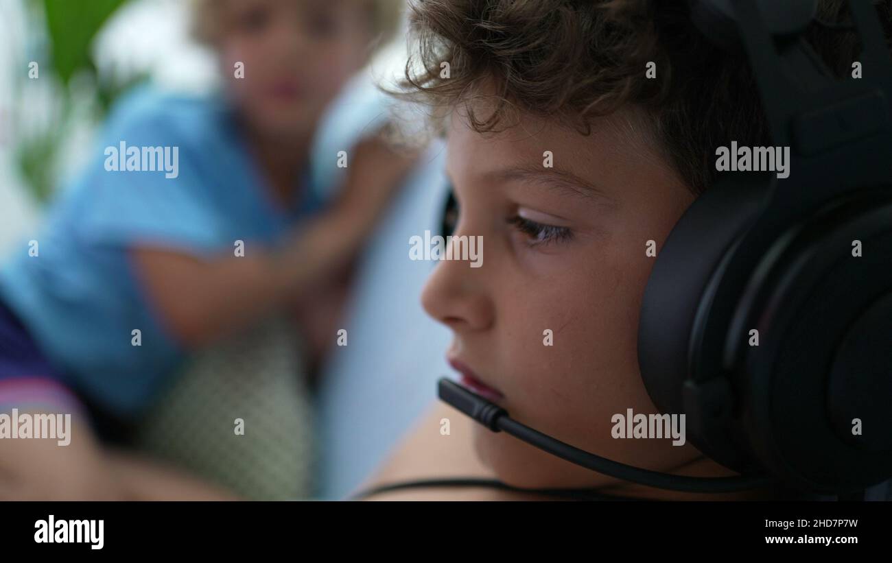Little boy playing video-game on tablet wearing headset with mic Stock ...