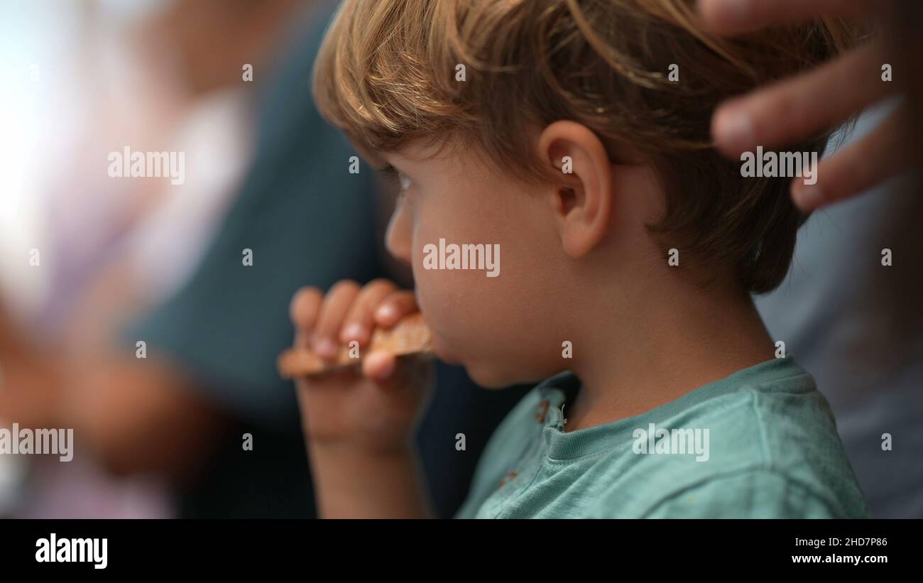 Little boy eating piece of bread, child eats food Stock Photo - Alamy