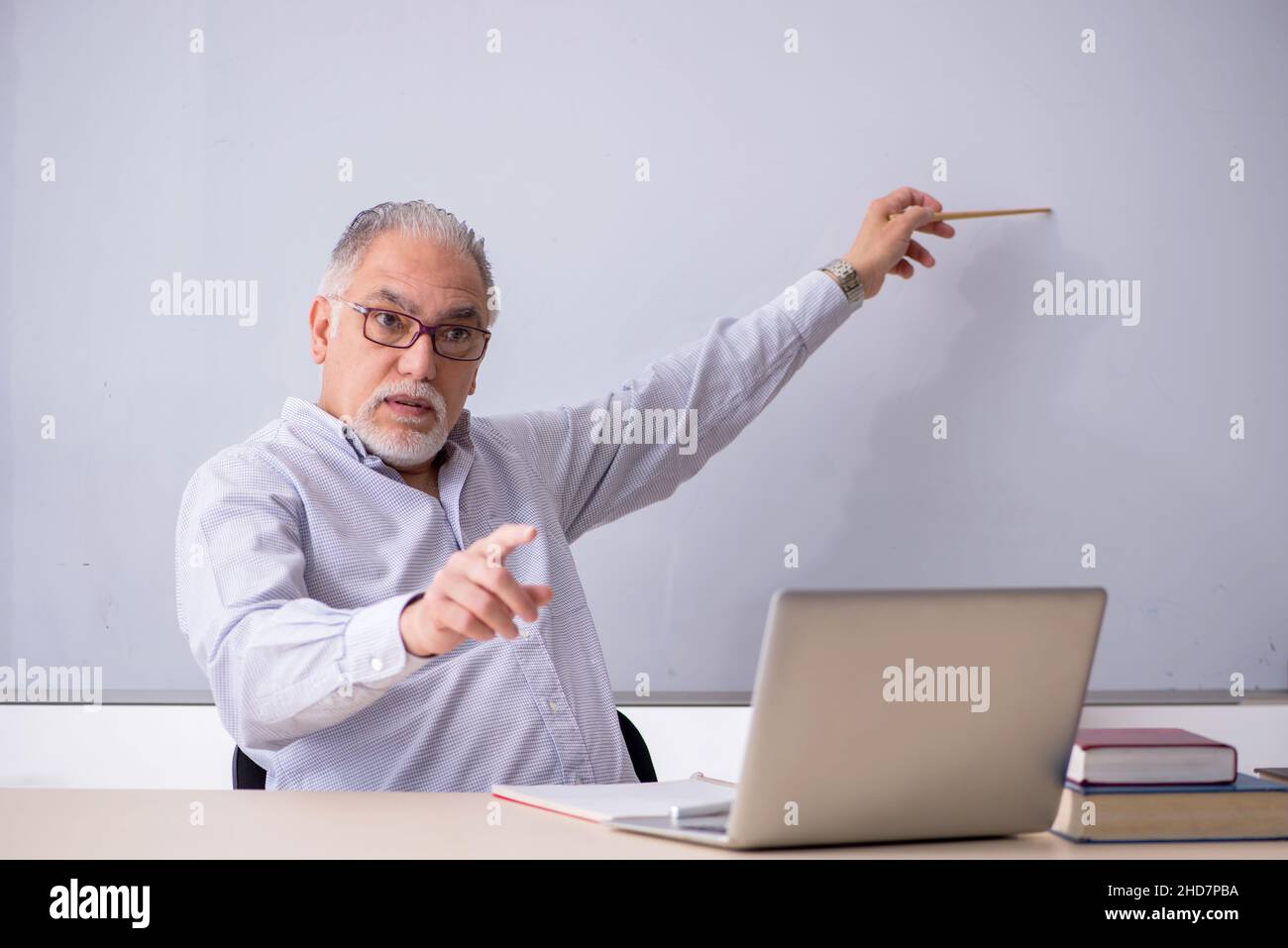 Old teacher in front of whiteboard Stock Photo - Alamy