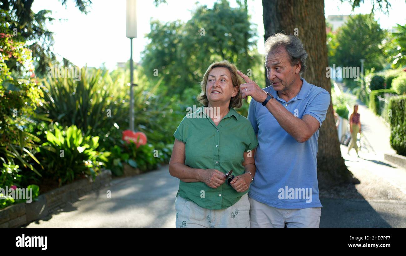 older couple walking together, senior people relationship outside in ...