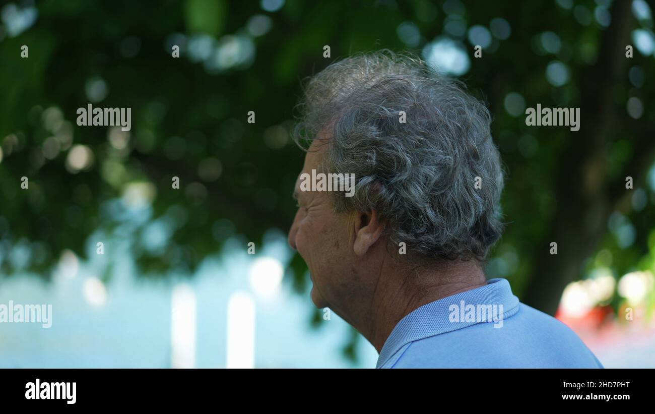 One happy older man walking outside during sunny day, pensive ...