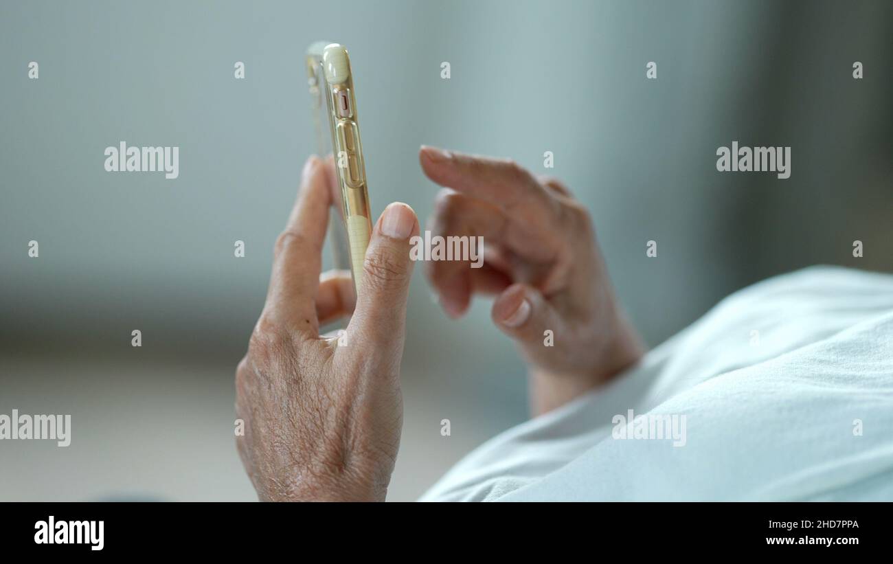 Person holding phone, close-up hands using cellphone Stock Photo - Alamy