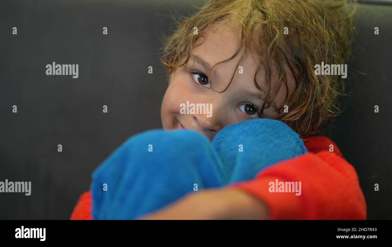 Shy little boy. bashful kid lying down to rest Stock Photo - Alamy