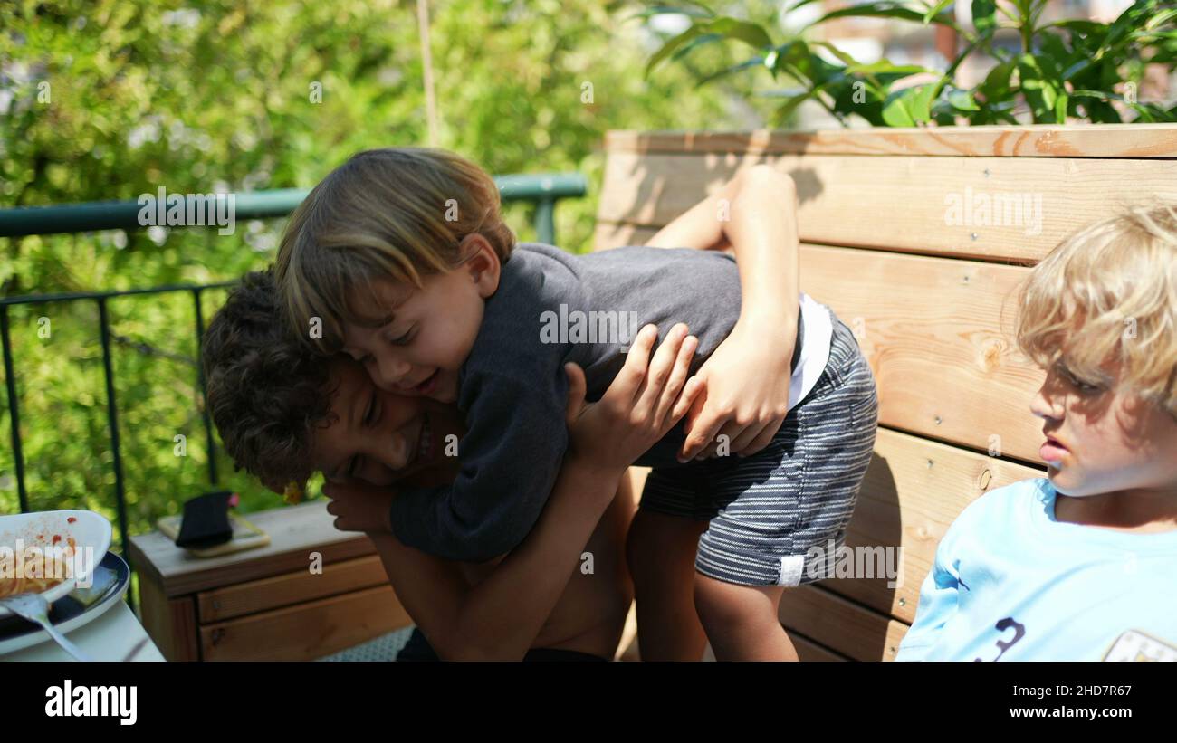Two brothers hugging outside, smaller sibling embraces brother Stock ...