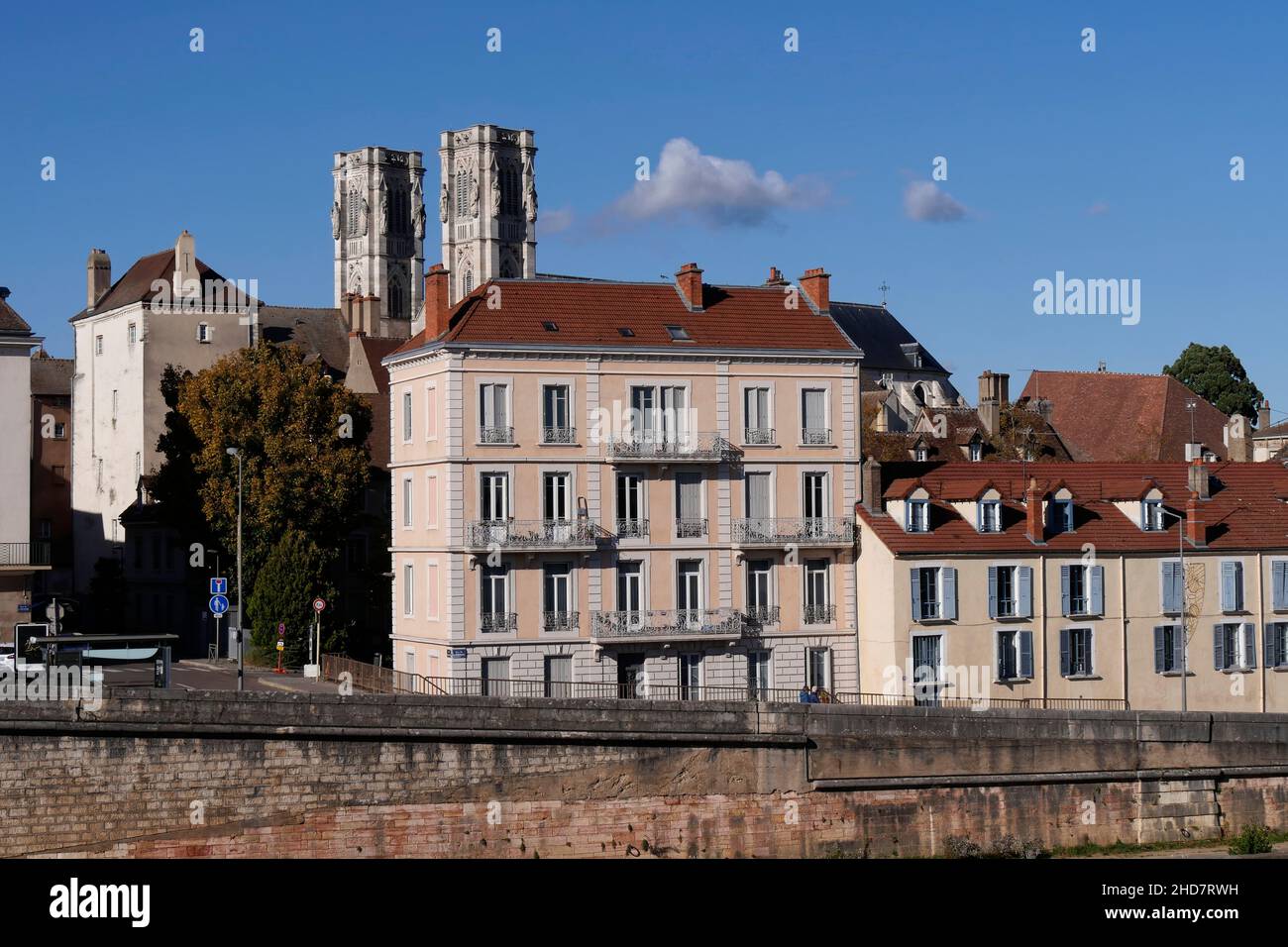 twin bell towers of Chalon cathedral tower over riverside buildings ...