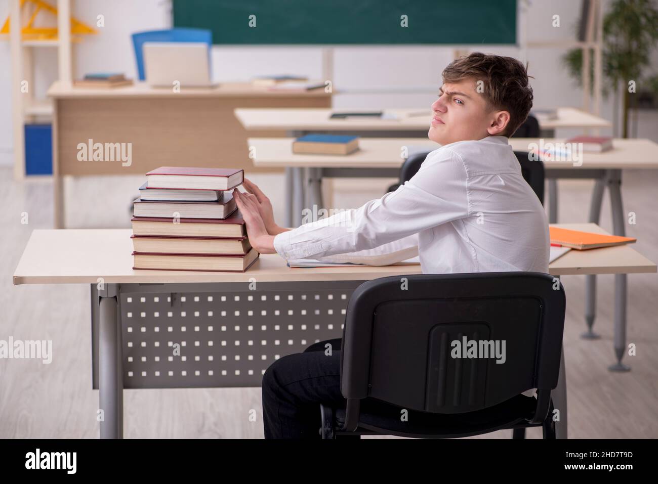 Male pupil sitting in the classrom Stock Photo - Alamy