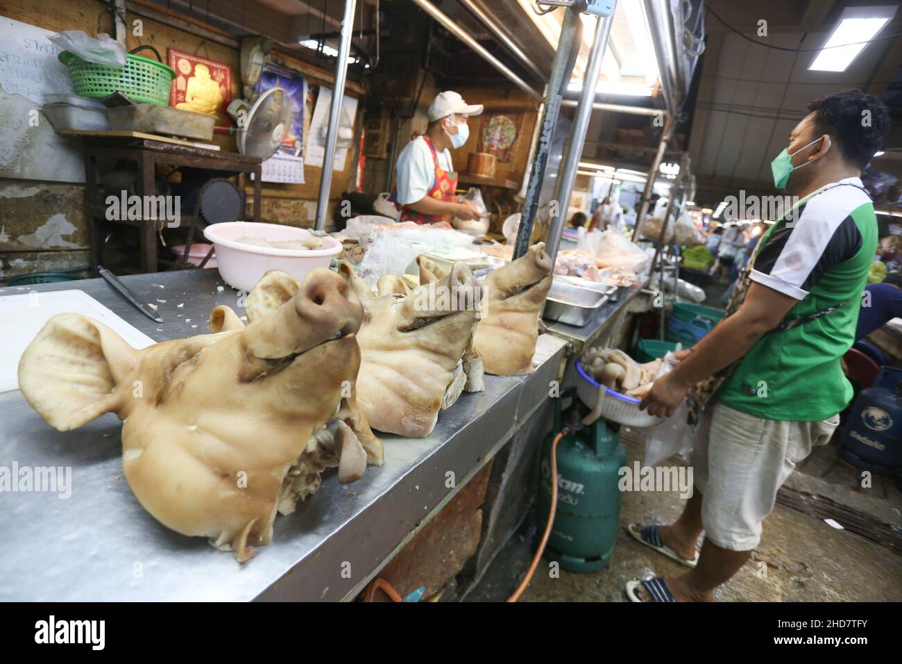Pig heads for sales seen on display at a market while the retail price ...