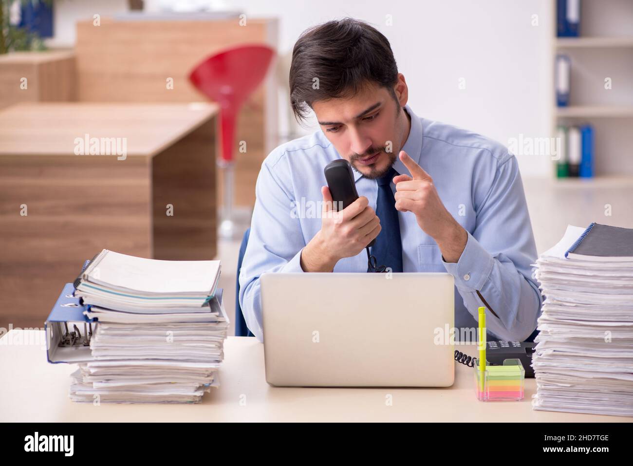 Young businessman employee and too much work in the office Stock Photo ...