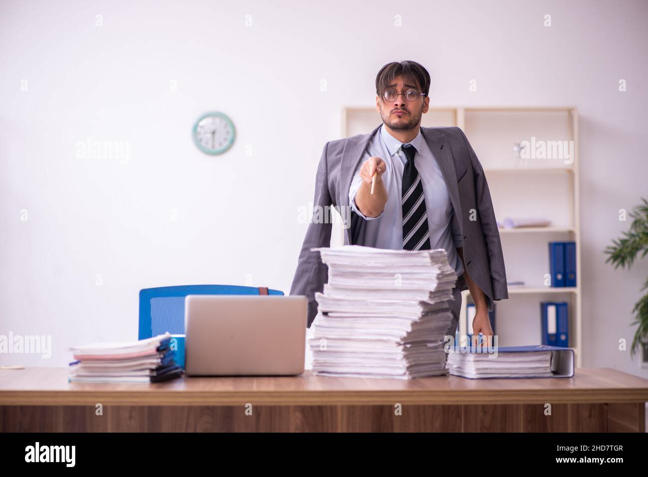 Funny young employee magician and too much work in the office Stock ...