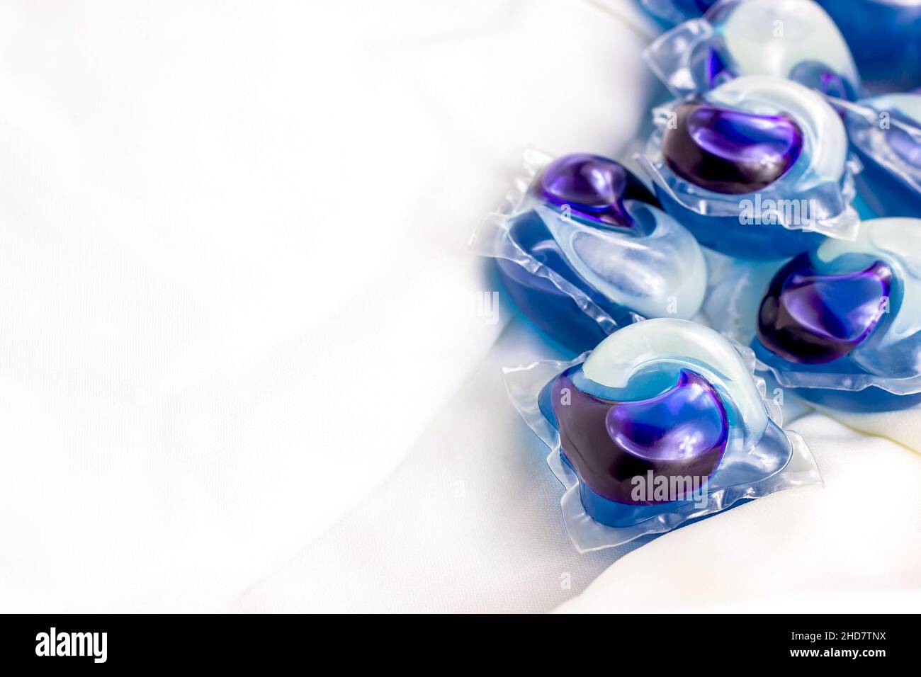 Bright blue washing pods and capsules with liquid detergent for machine ...