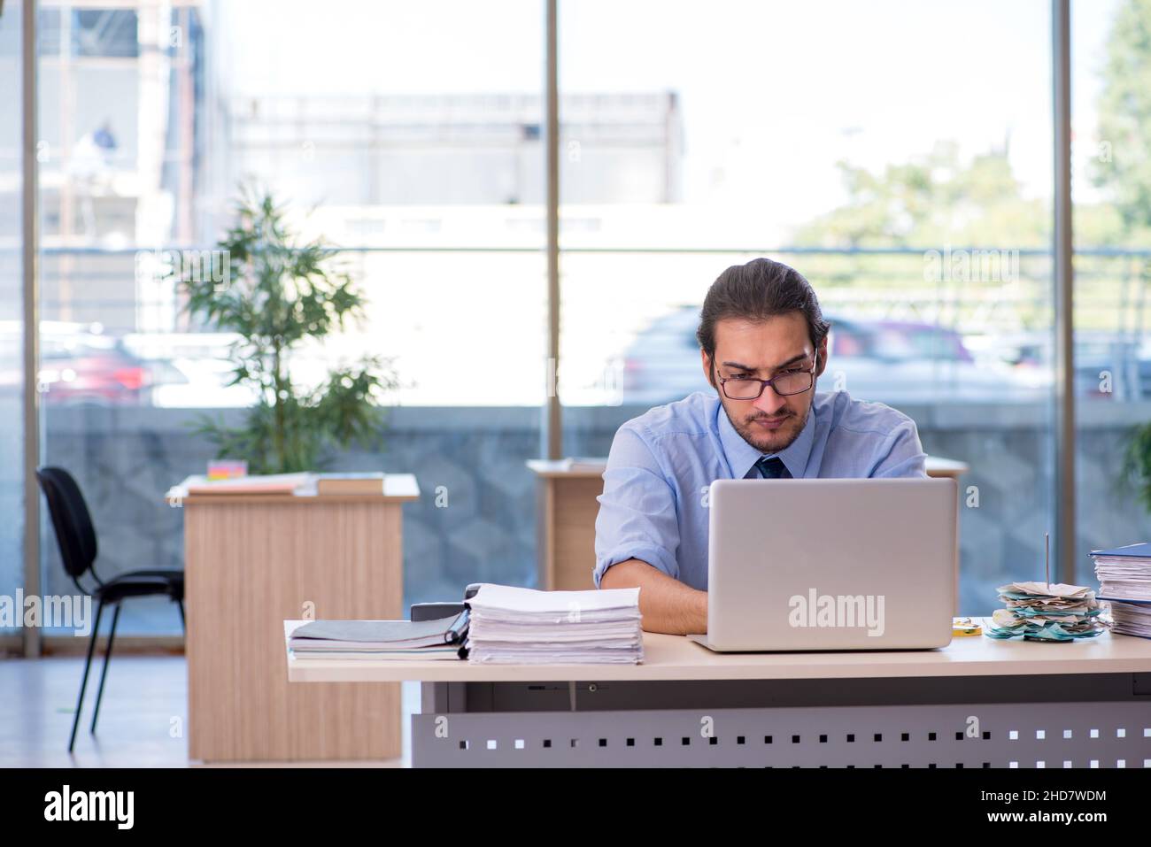 Young accountant working in the office Stock Photo - Alamy