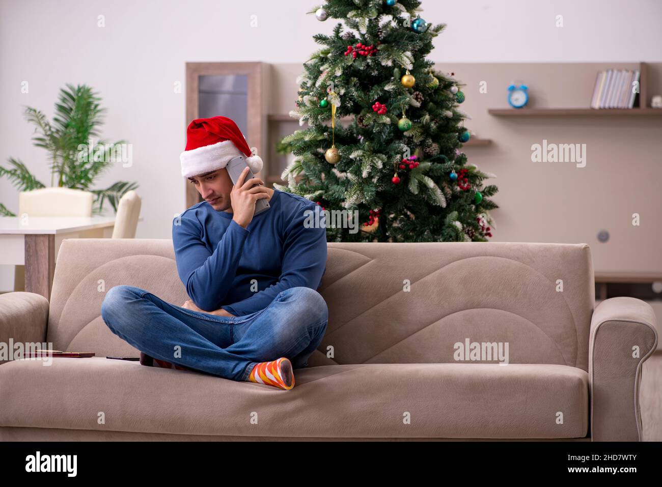 Young man celebrating new year alone at home Stock Photo - Alamy