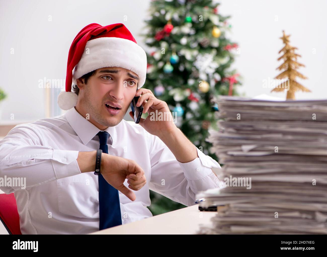 The young worker working in office on christmas shift Stock Photo - Alamy