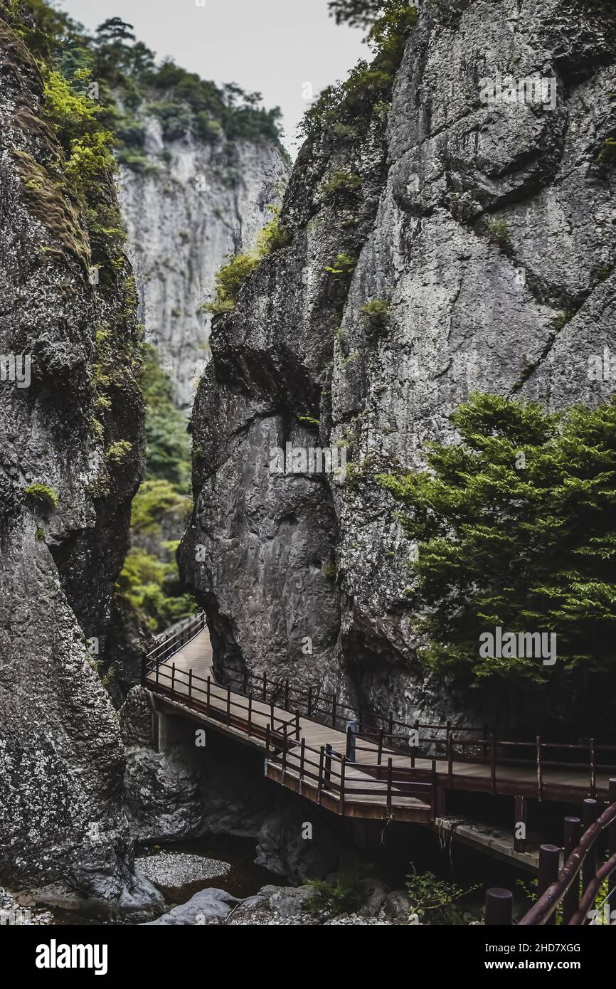 A path between a carved rock Stock Photo - Alamy
