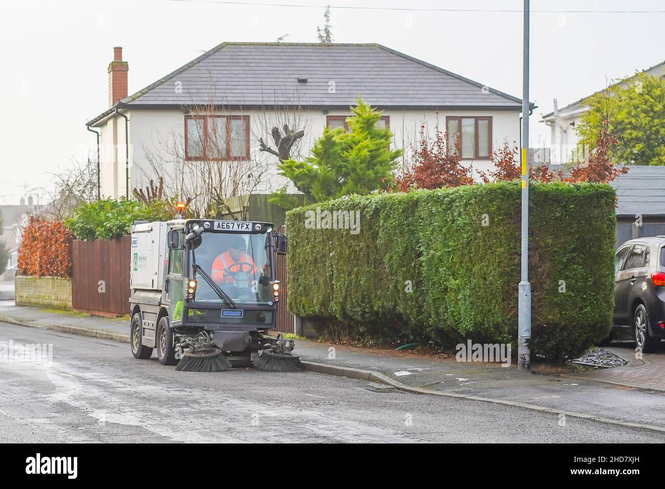 Front view of council mini road sweeper in operation cleaning the ...