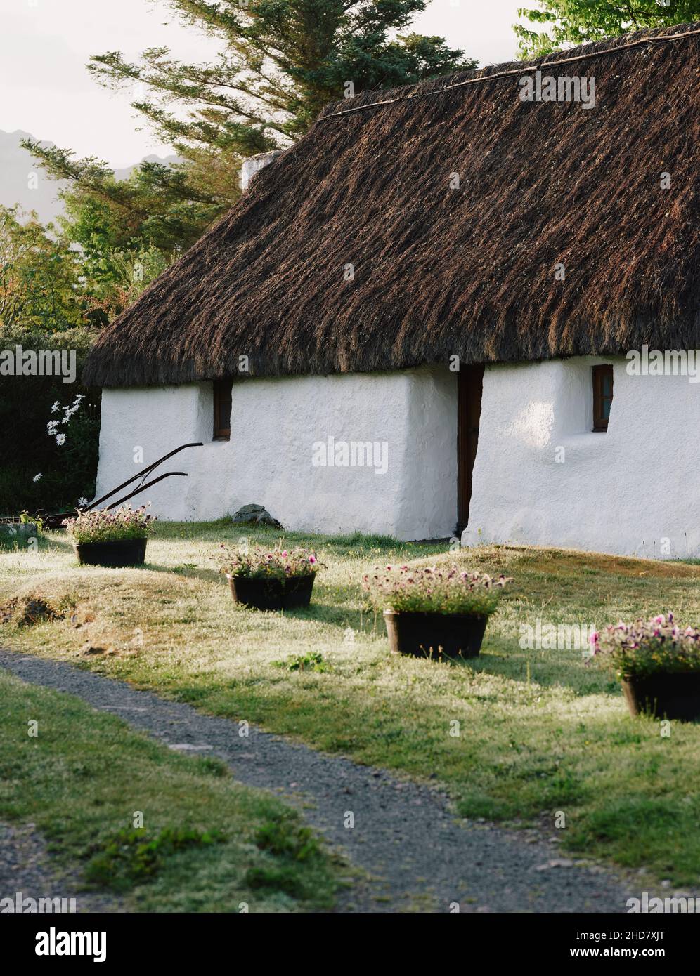 A traditional thatched croft cottage in Plockton village on the shores ...