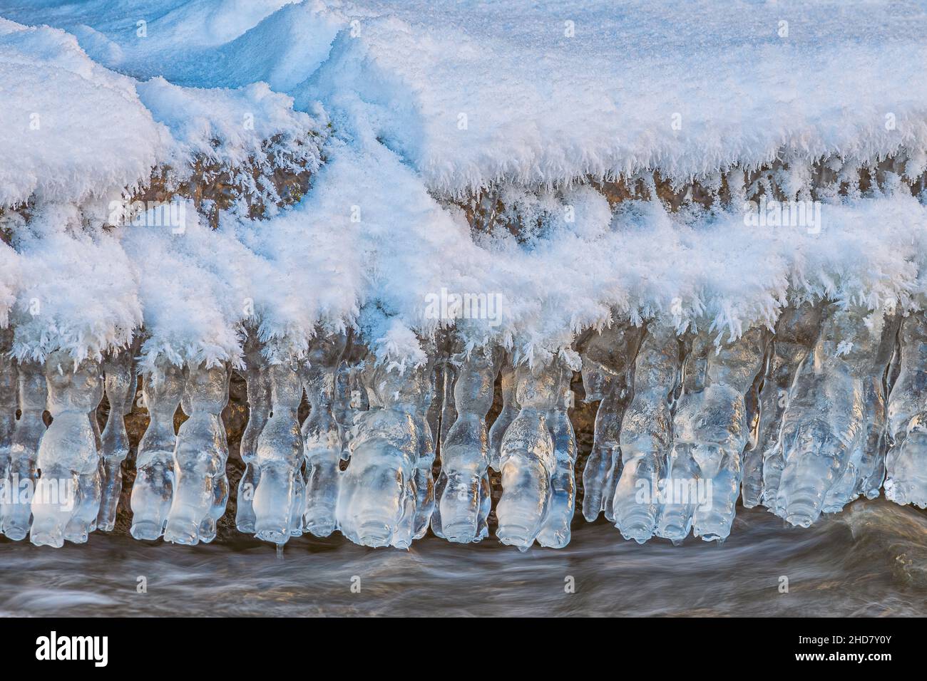 Icicles over the water in the river. Natural landscape. Winter ...