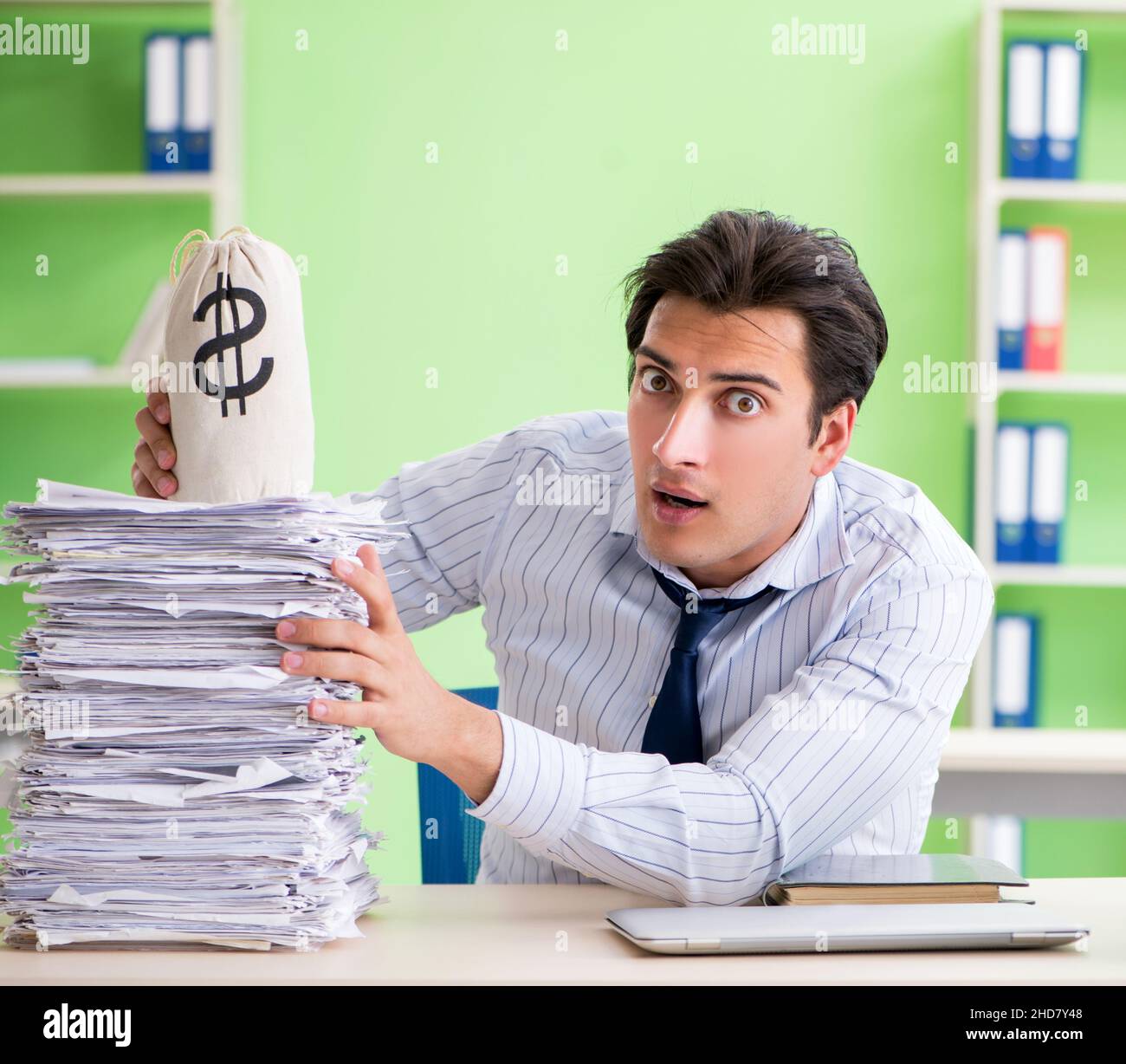 The businessman having problems with paperwork and workload Stock Photo ...