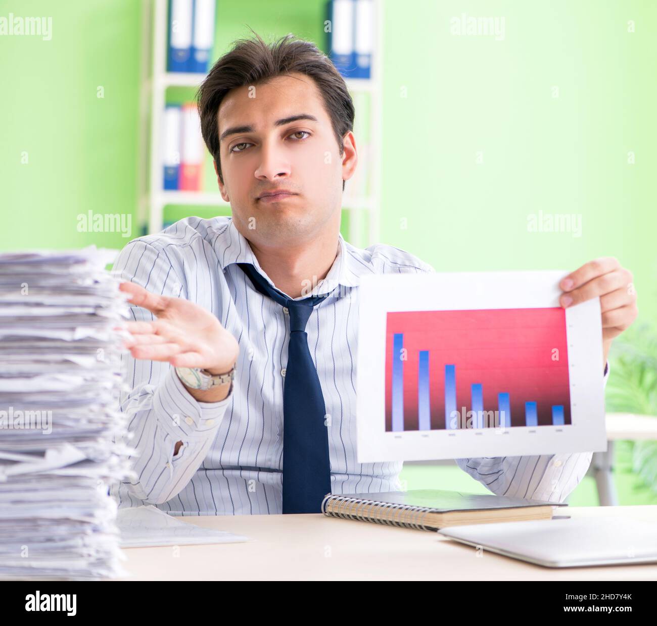 The businessman having problems with paperwork and workload Stock Photo ...