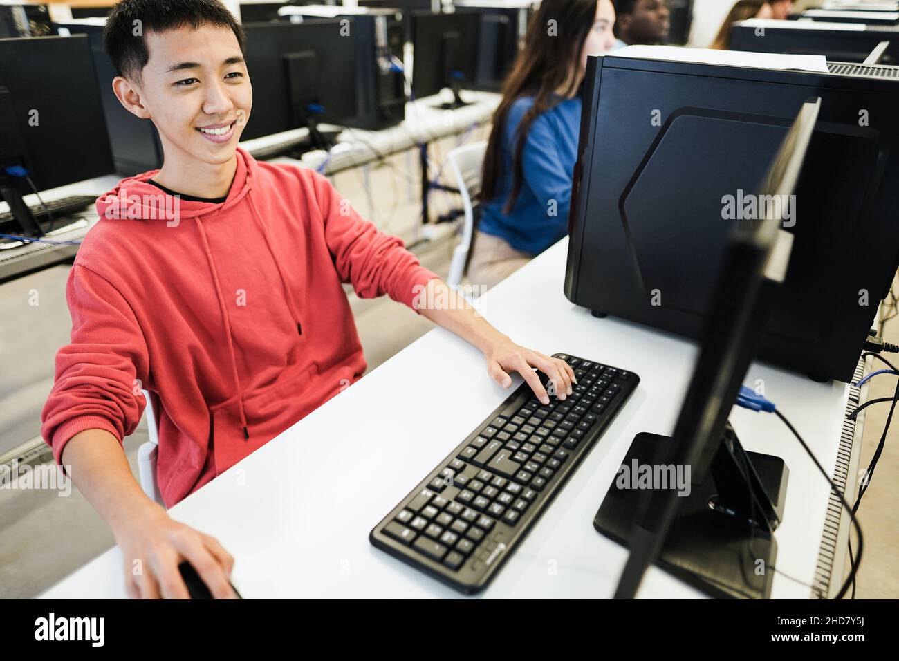 Young asian student using computer inside computer room at school ...