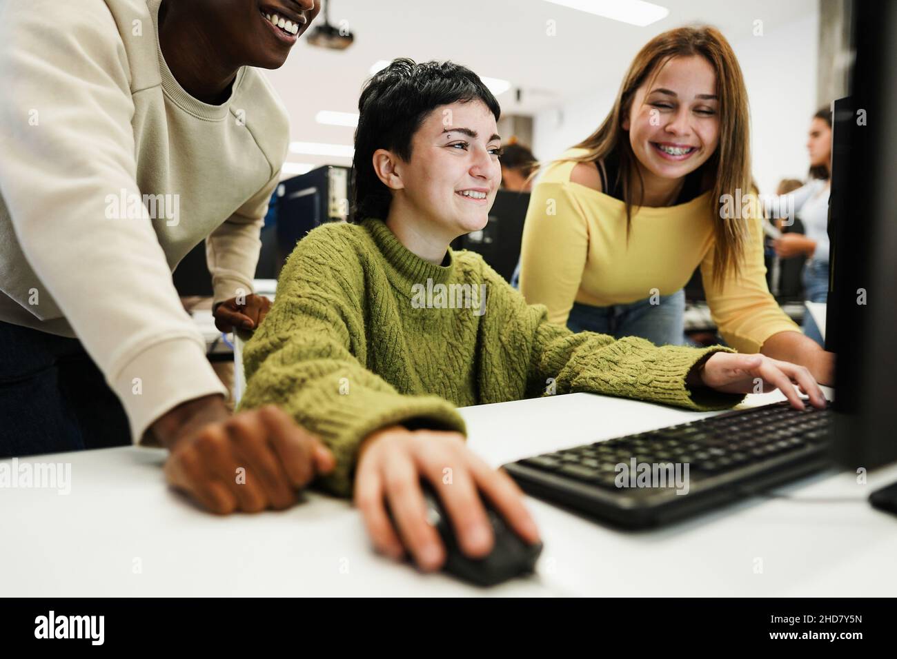 Young students using computers inside business class at school - Focus ...