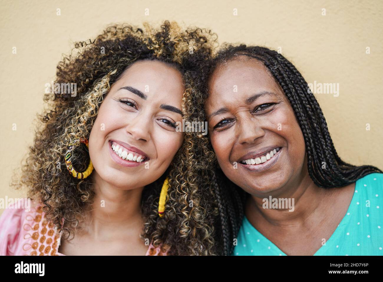 Happy african mother and daughter smiling on camera - Focus on faces ...