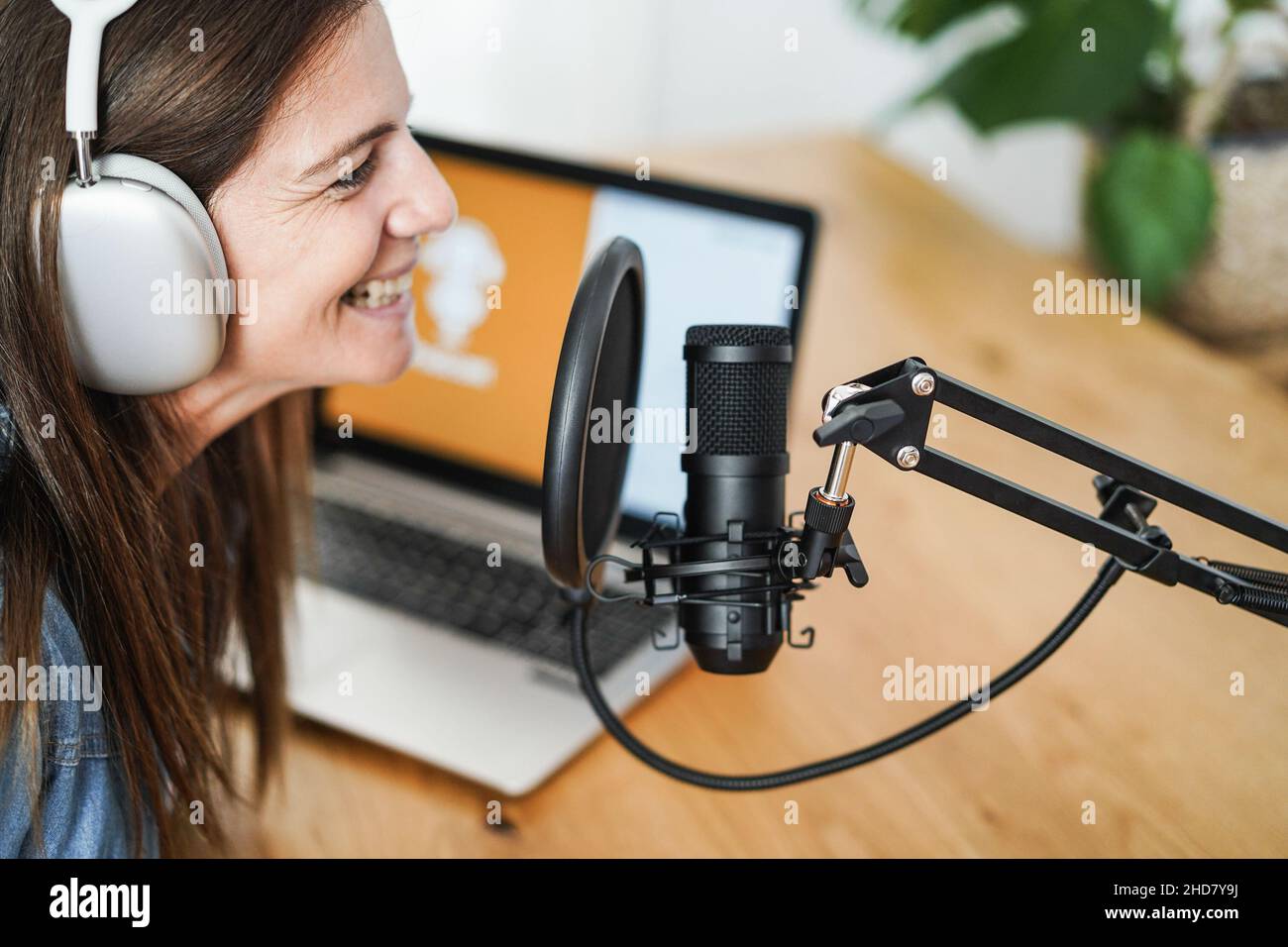 Mature woman live streaming podcast session at home studio - Soft focus ...