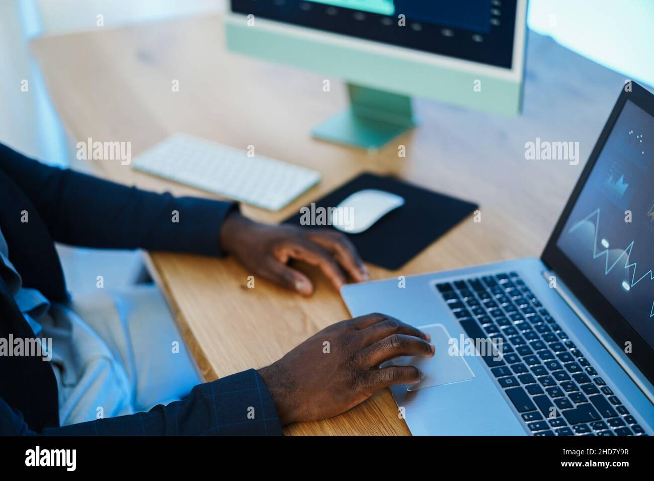 African trader studying stock market at home - Focus on right hand ...