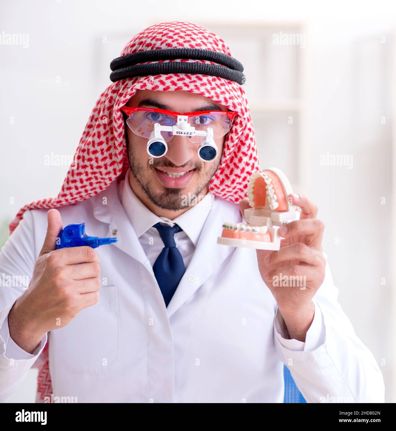 The arab dentist working on new teeth implant Stock Photo - Alamy